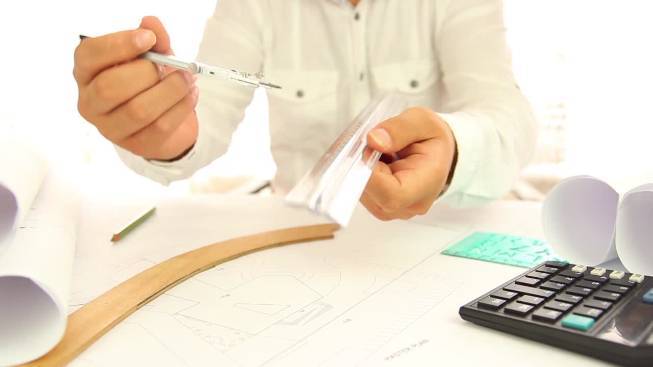 Premium stock video - Architect using ruler pencil for project