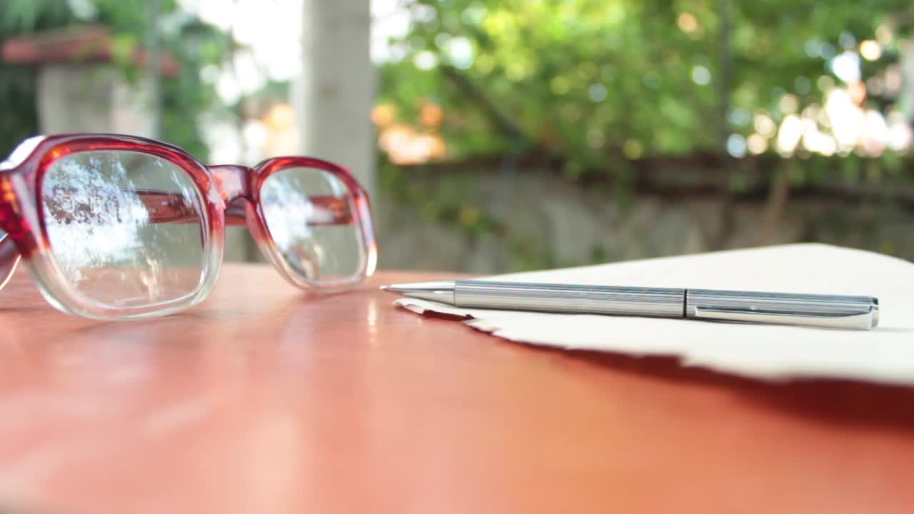 Premium stock video - Writing romantic letter with glasses