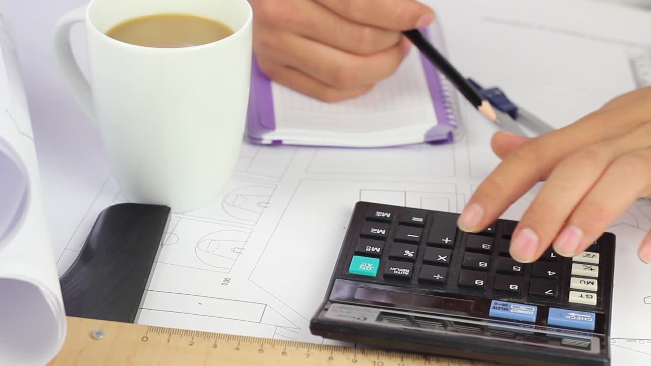 Premium stock video - Architect calculator using for project