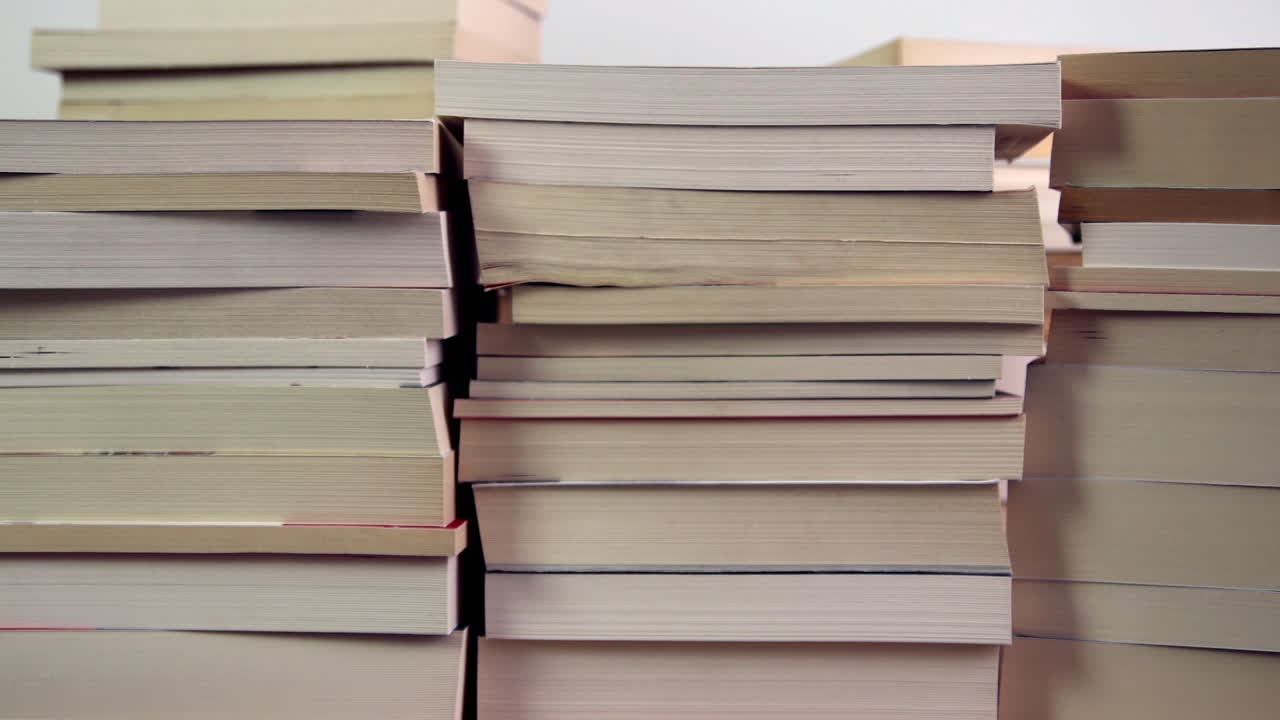 Premium stock video - Books disappear from bookshelves timelapse