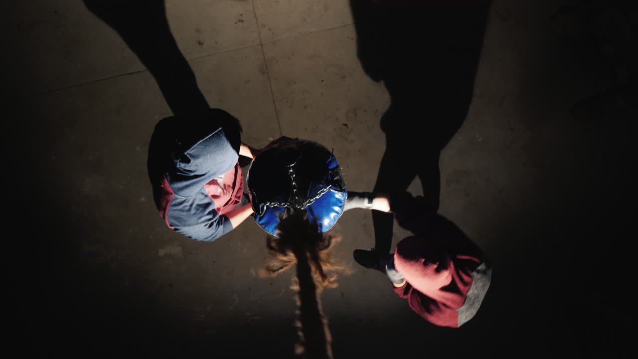 Premium stock video - Top view of boxer and partner training in the gym