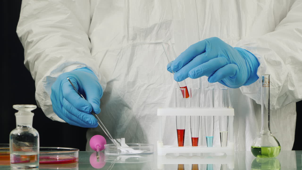 Premium stock video - Technician in uniform does a blood test