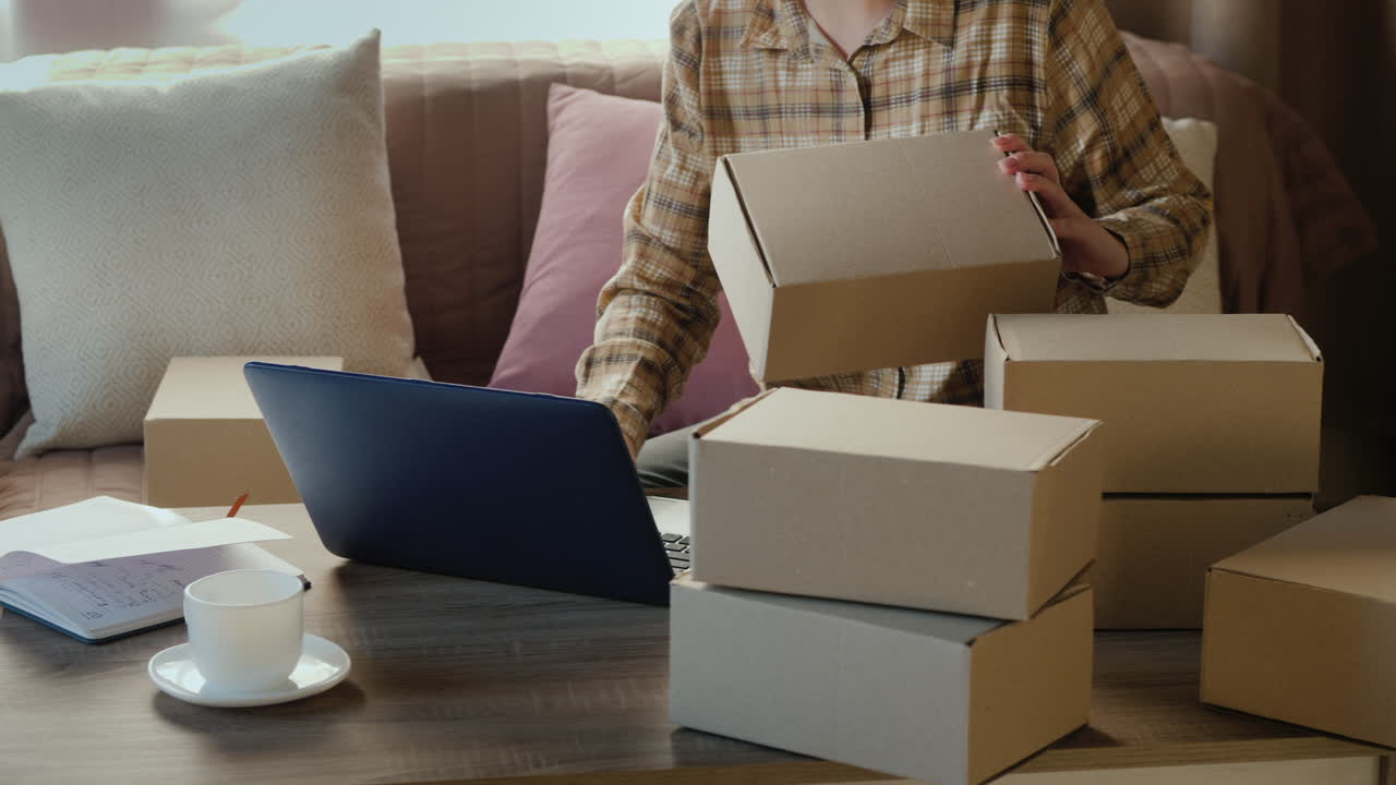 Premium stock video - Working from home - a woman sorts parcels in her room