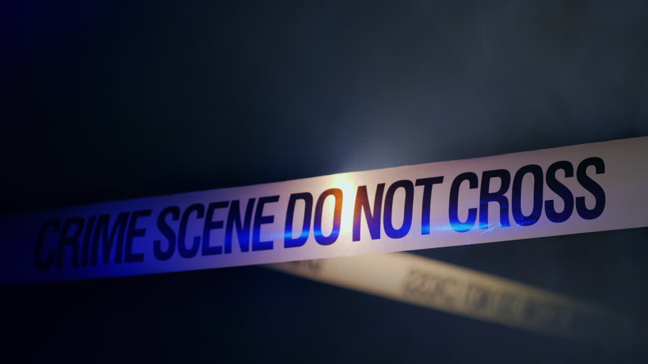 Premium stock video - Yellow ribbons encloses crime scene lit by police ...