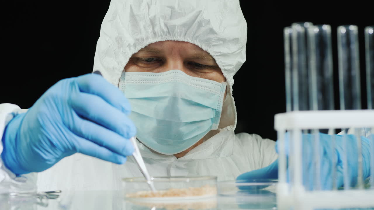 Premium stock video - Pharmacist researcher conducts experiments on ...