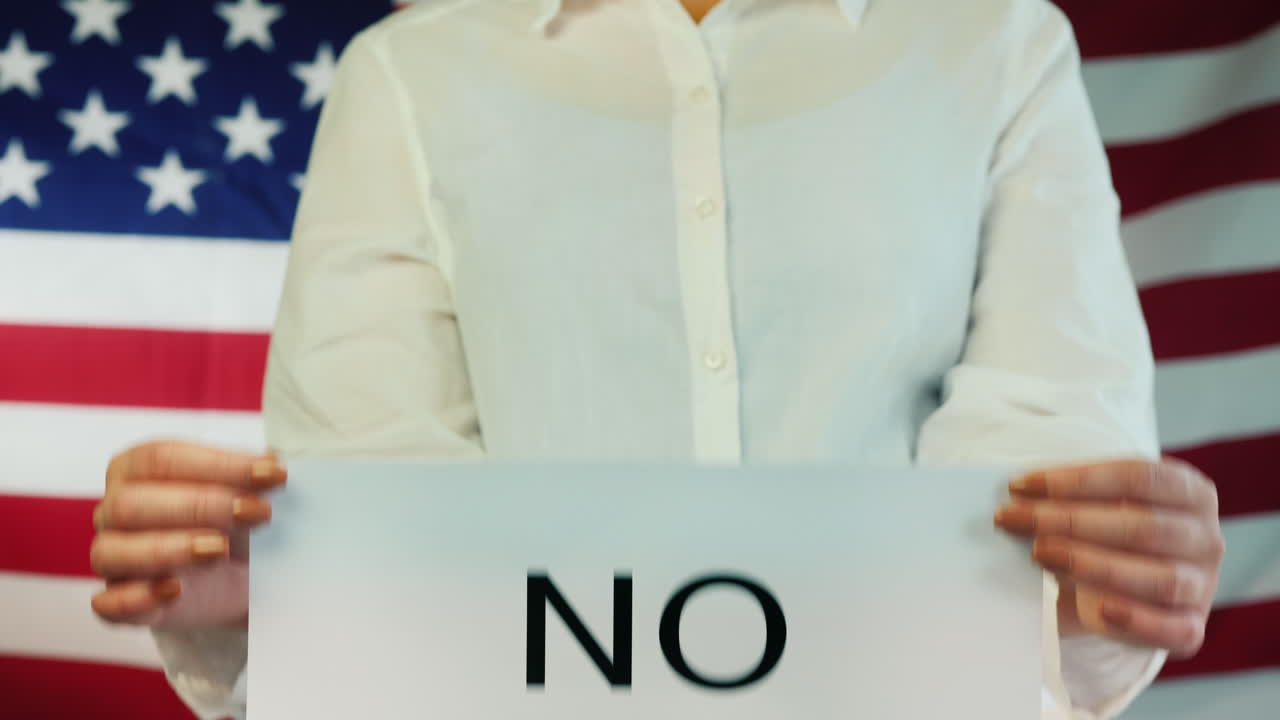 Premium stock video - Woman holds poster stating no more on american ...