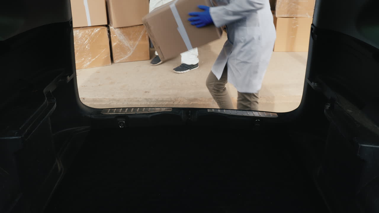 Premium stock video - View from the trunk of the car - loading boxes ...