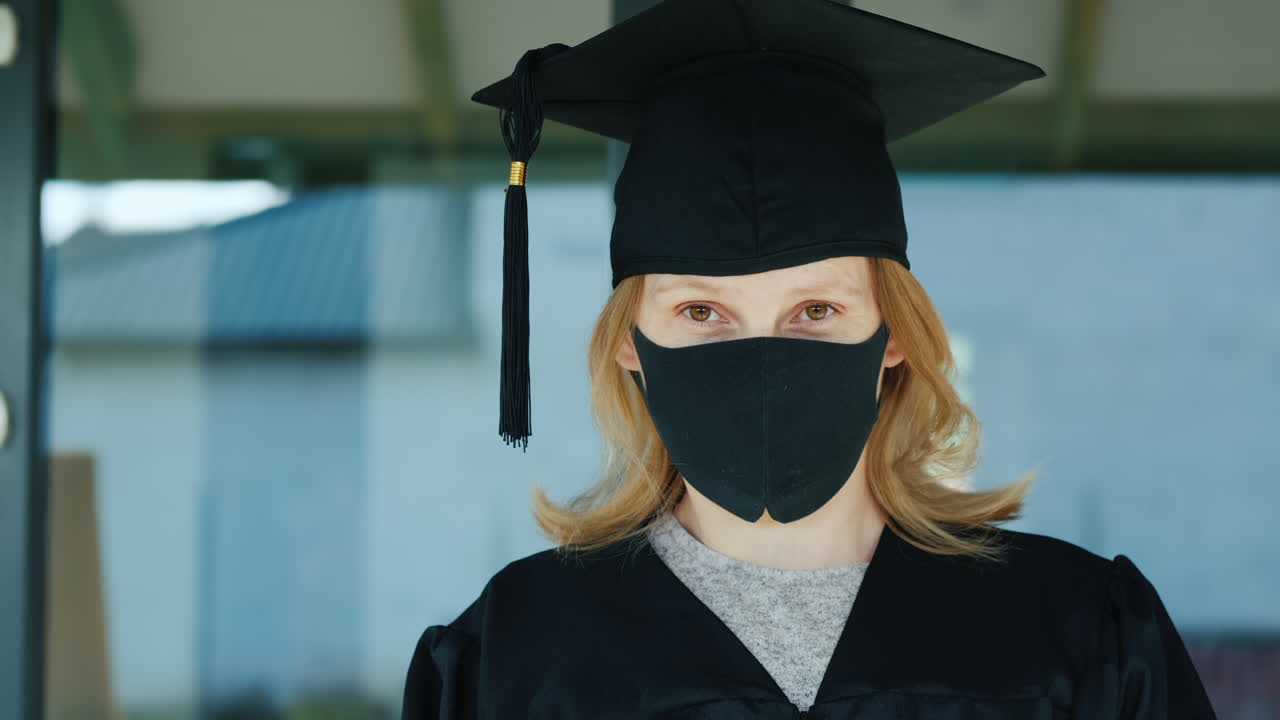 Premium stock video - Portrait of a masked graduate on the doorstep of ...