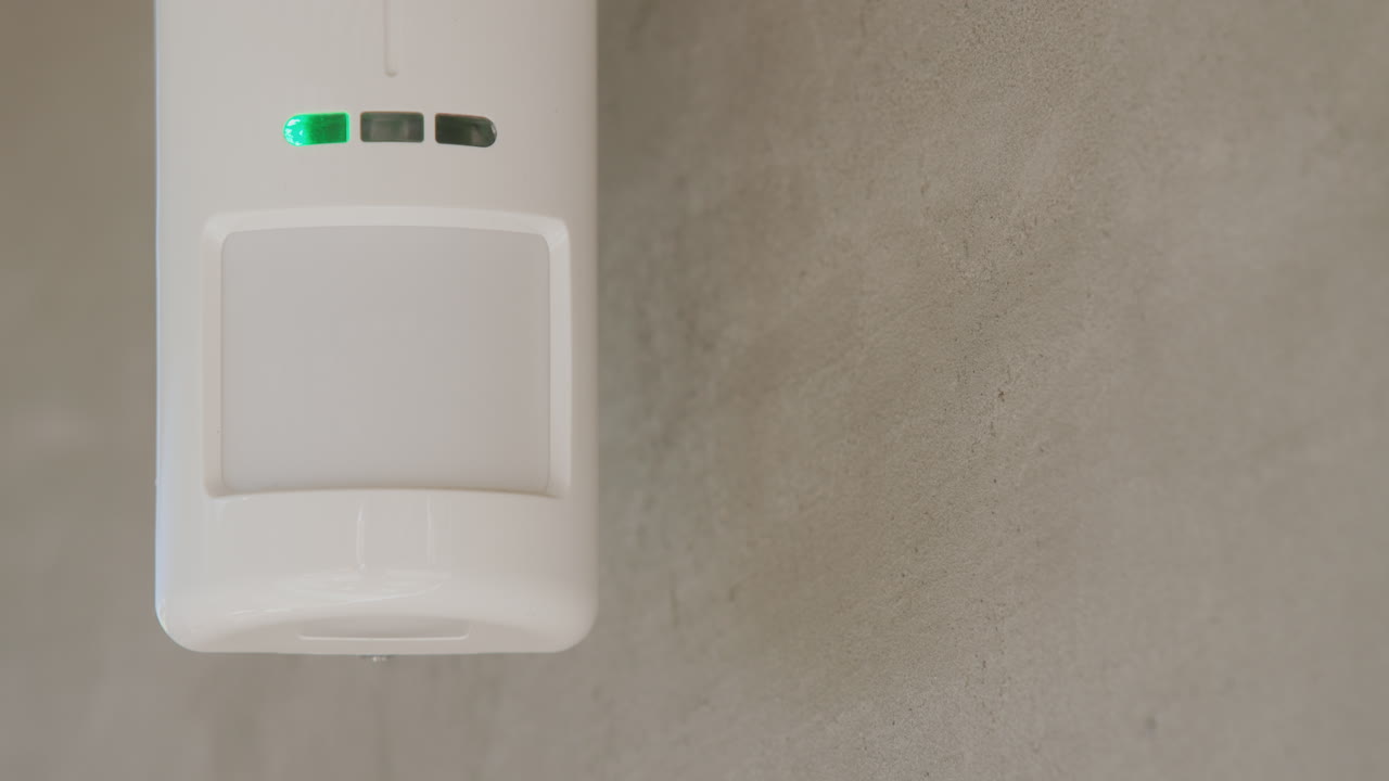 Premium stock video - Security alarm sensor on the wall of a house 1