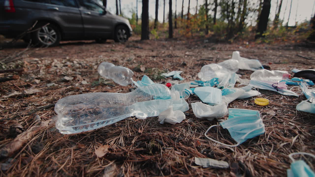 Premium stock video - Person throws garbage in the woods