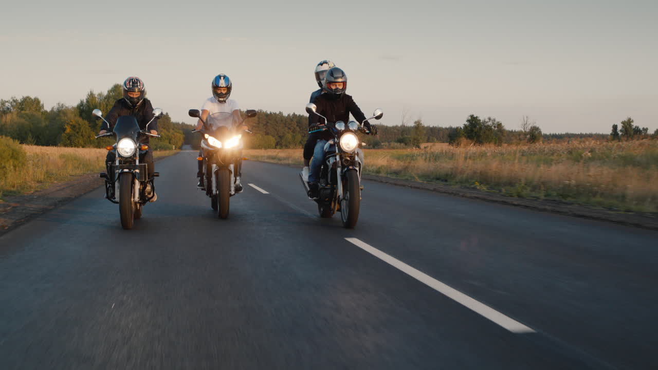 Premium stock video - A group of bikers rides along the highway in a row 1