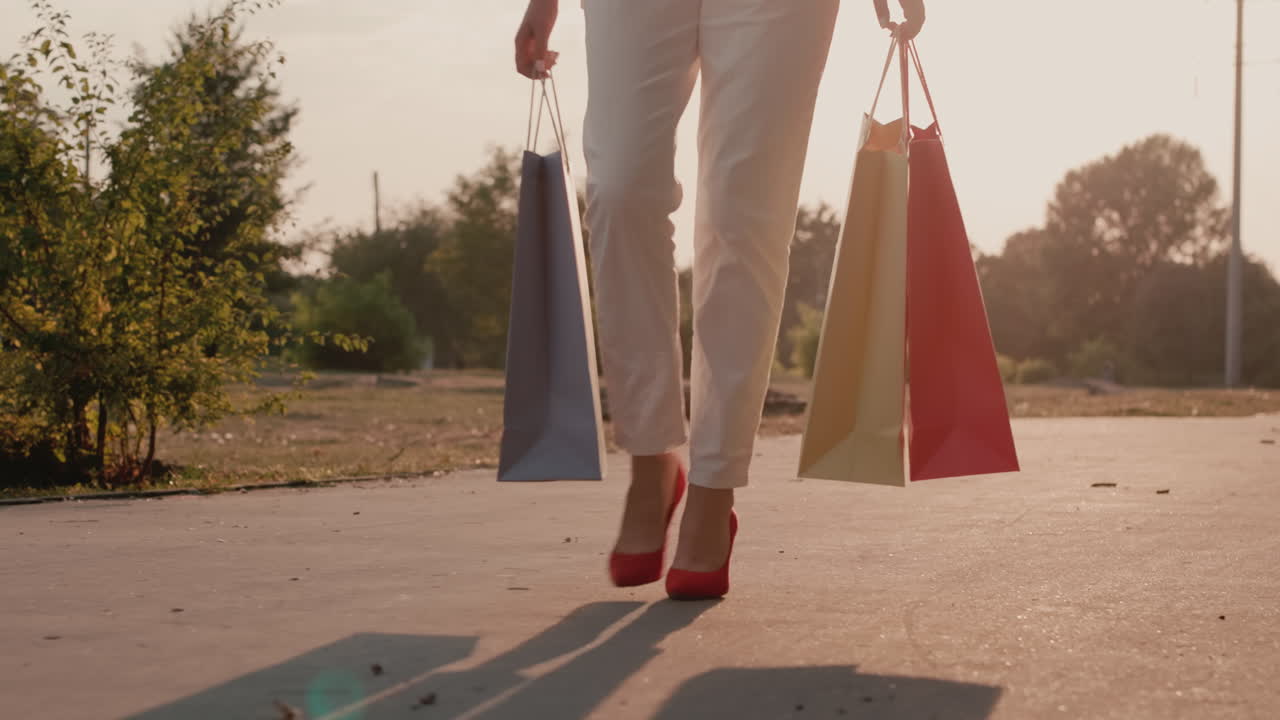 Premium stock video - Stylish woman walks down the street with packages ...