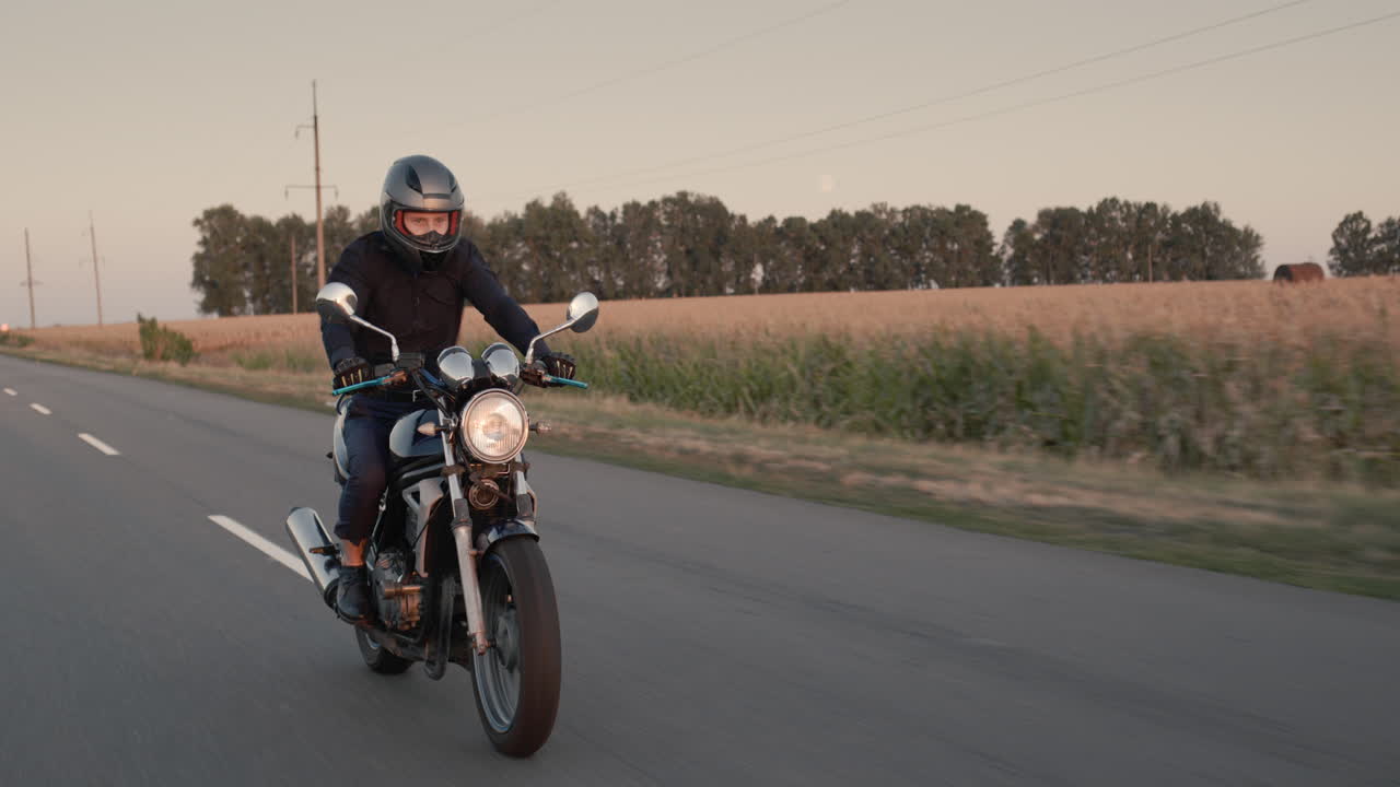 Premium stock video - A motorcyclist rides a motorcycle before sunset 1