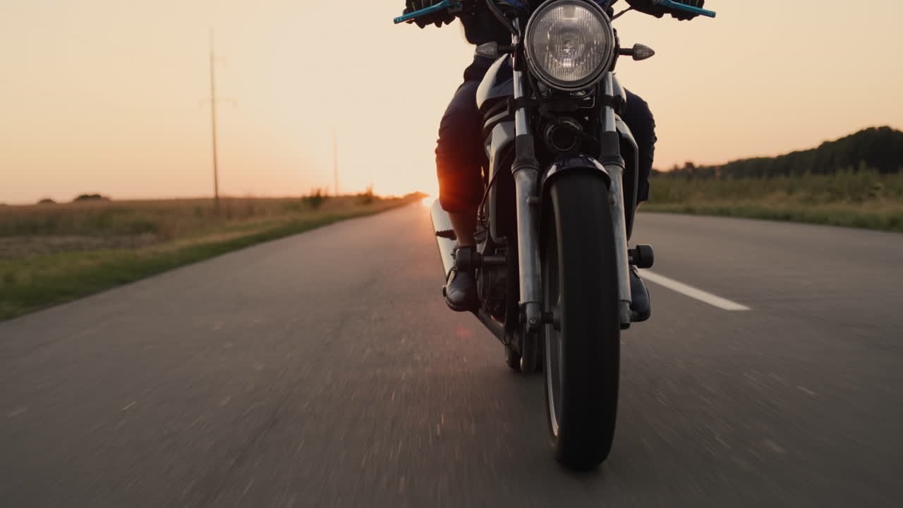 Premium stock video - Silhouette of a motorcycle biker riding on the ...