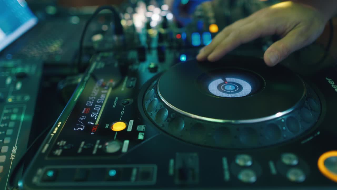 Premium stock video - Dj works at the remote control at the disco