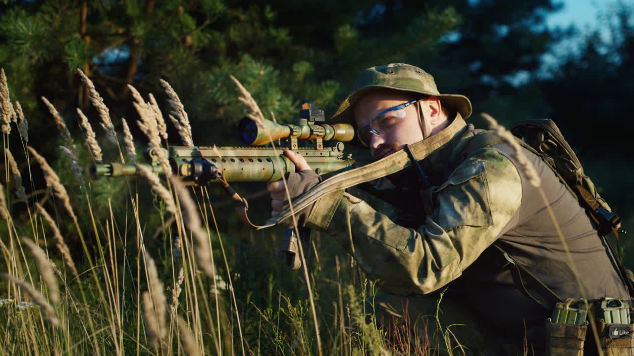 Premium stock video - A solider aims his rifle