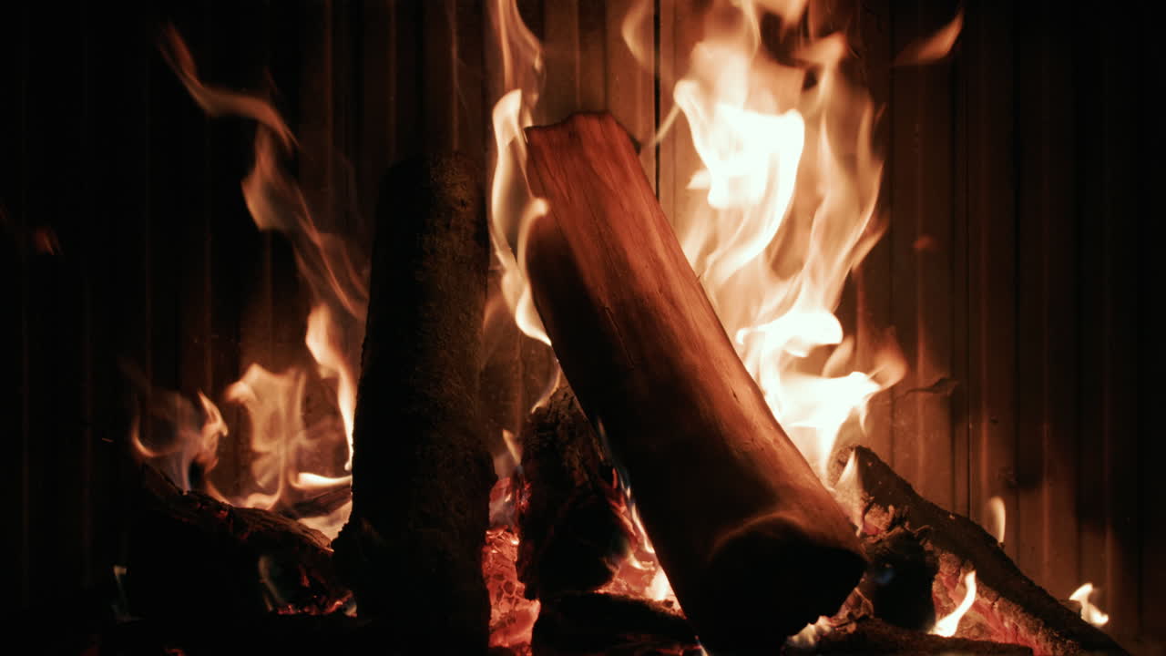 Premium stock video - The wood is burning in a modern fireplace
