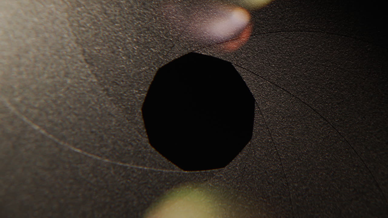 Premium stock video - Close-up of the lens's aperture illuminated by a ...