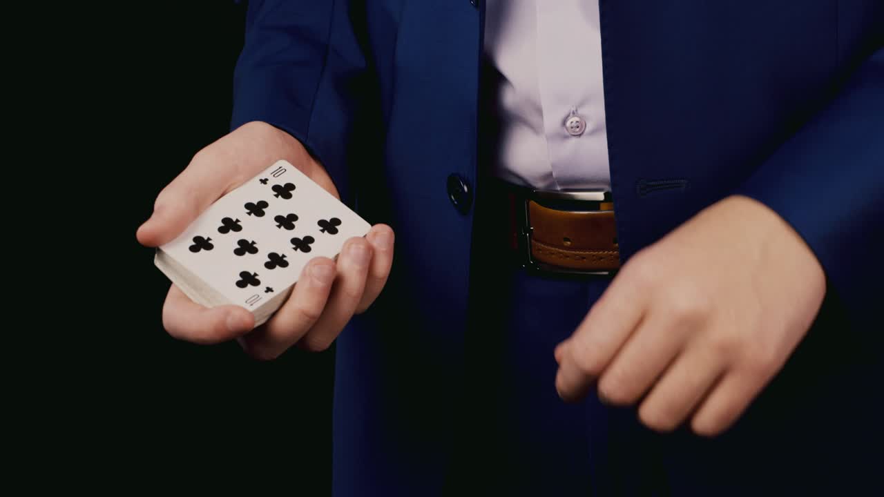 Premium stock video - The magician does tricks with playing cards 1