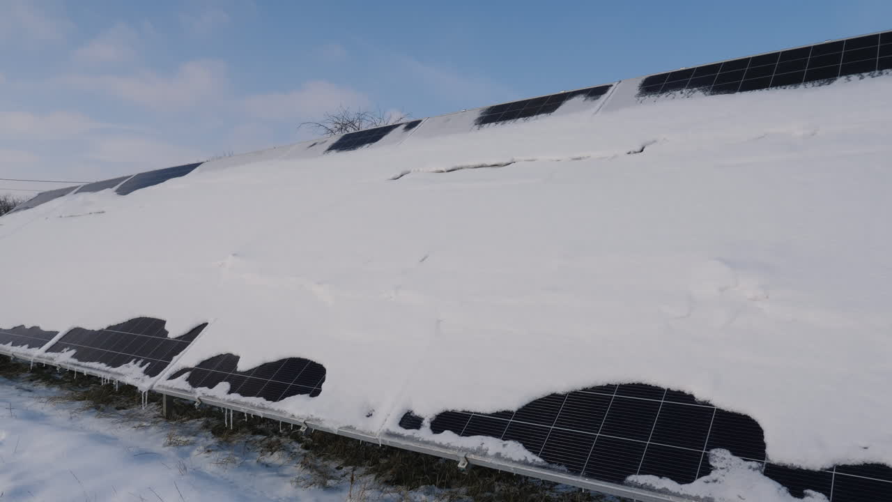 Premium stock video - A layer of snow on the panels of a solar power ...