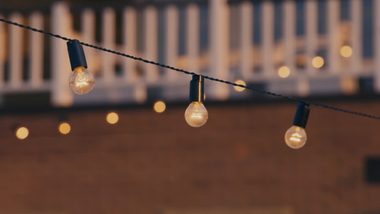 Premium stock video - Light bulb string at an outdoor party