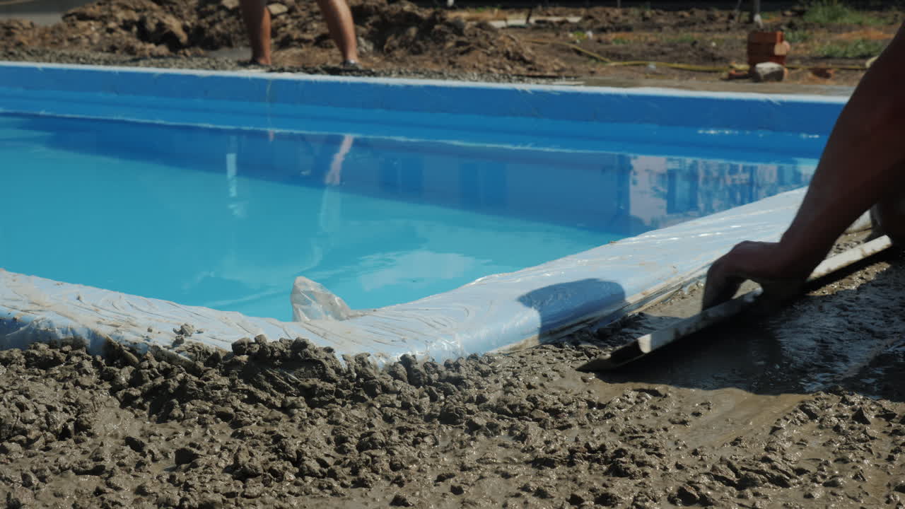 Premium stock video - Concrete flows down the gutters where workers ...