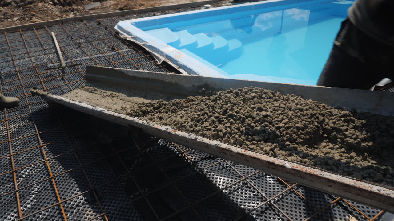 Premium stock video - Concrete flows down the gutters where workers ...