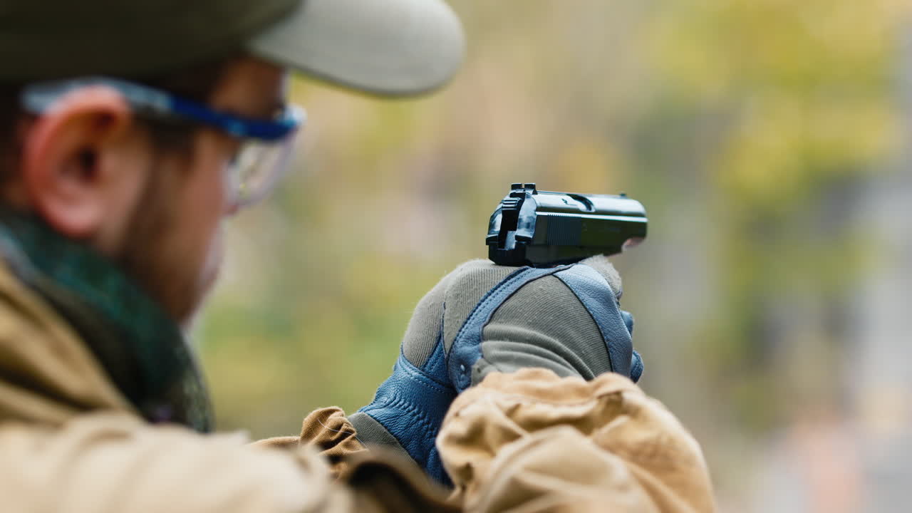 Premium stock video - A man plays airsoft with a pistol in his hand 3