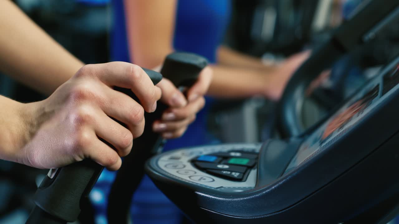 Premium stock video - Athlete's hands adjusts the treadmill