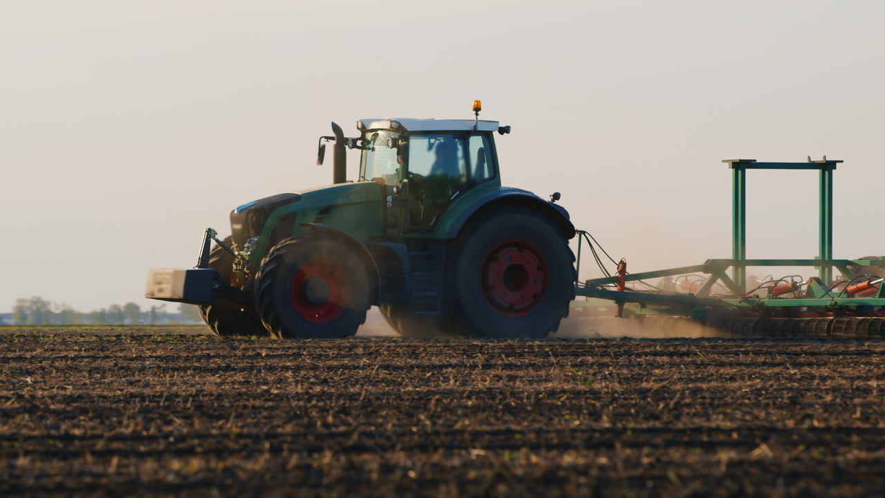 Premium stock video - Tractor plows through the soil 1