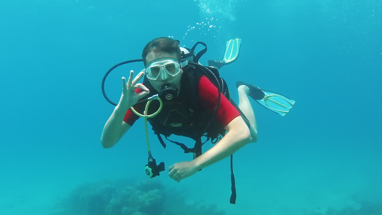 Premium stock video - Diver shows okay hand sign