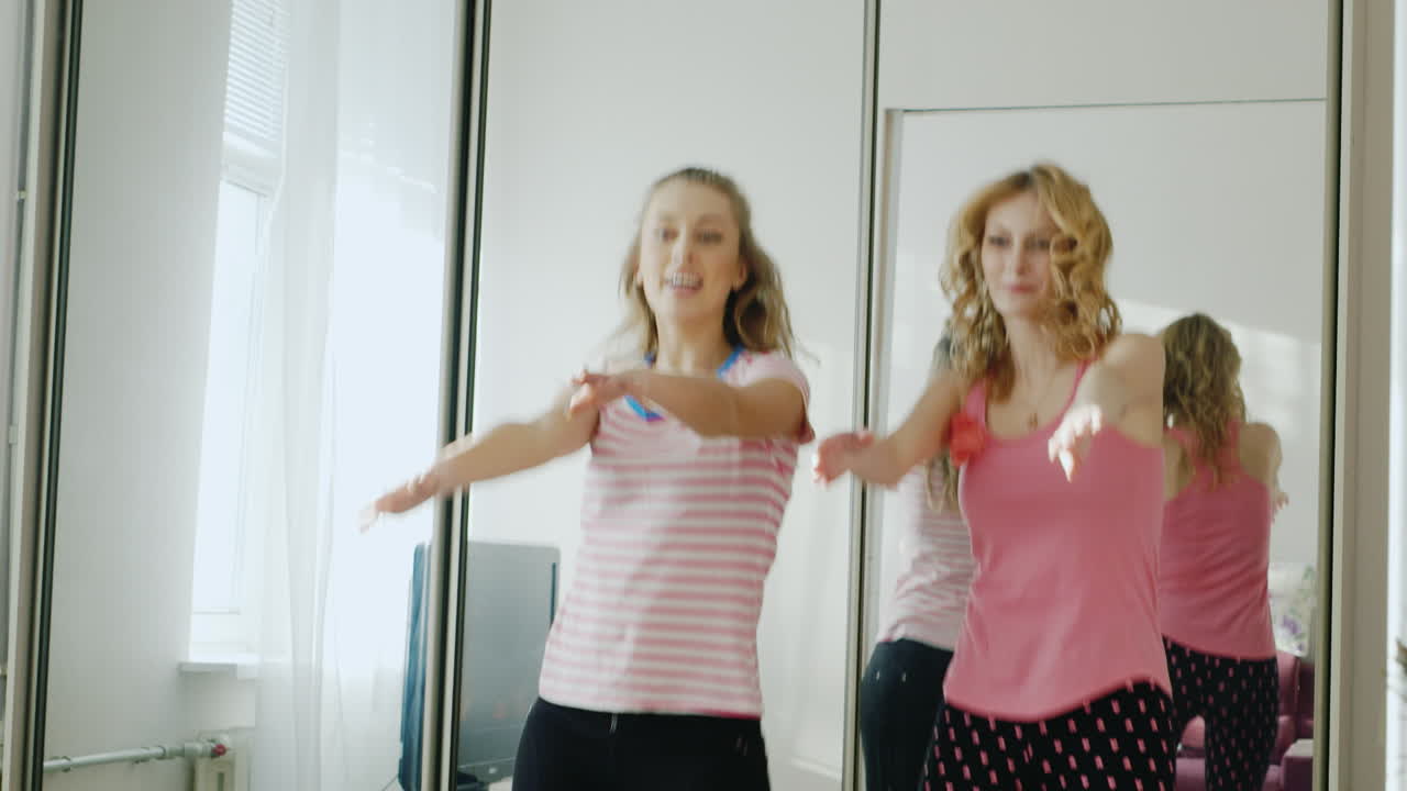 Premium stock video - Two young girlfriends teens learn to perform ...