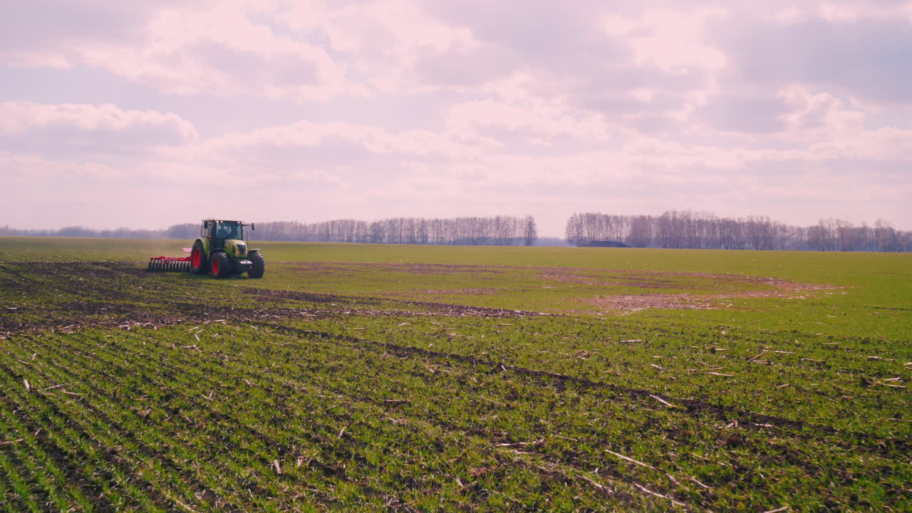 Premium stock video - A picturesque landscape - a tractor in the field ...