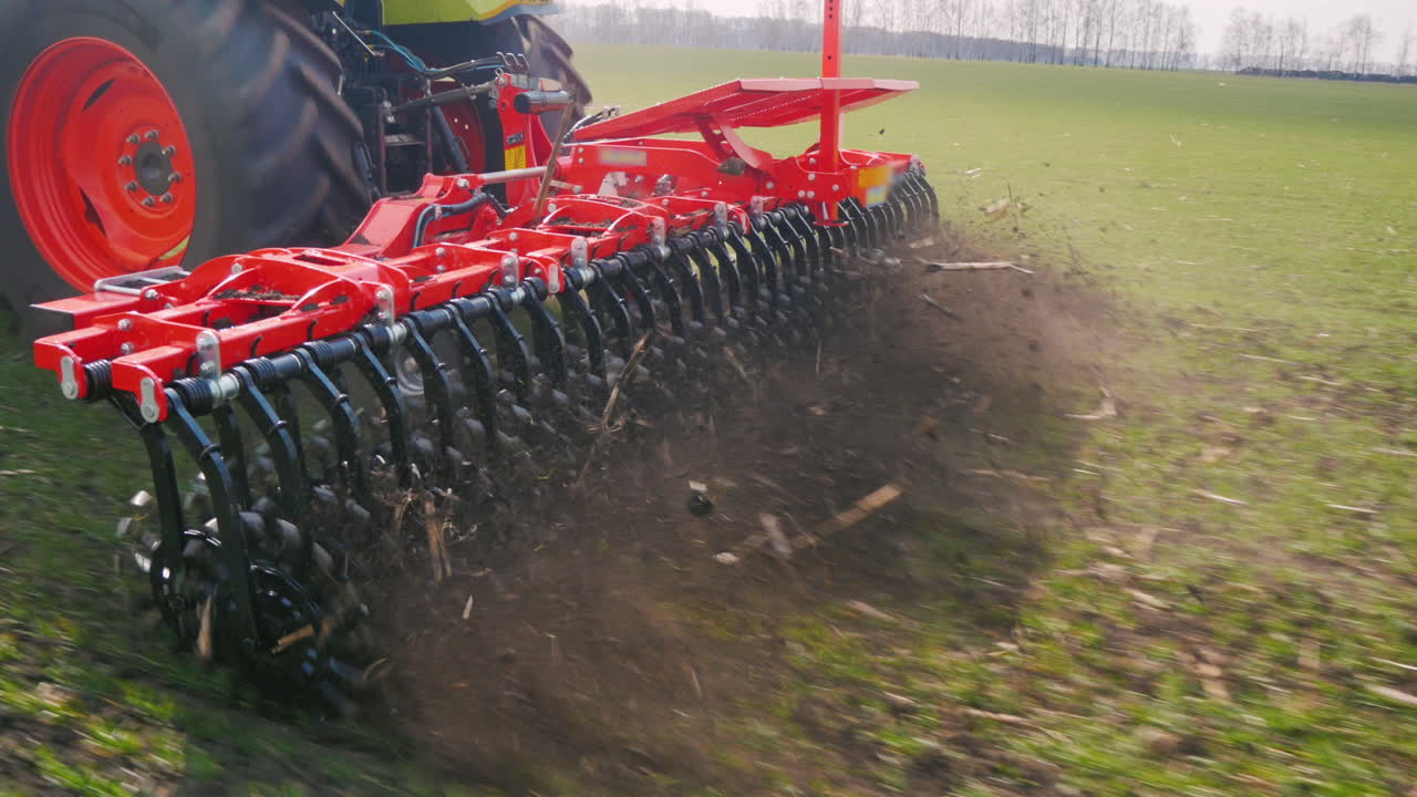 Premium stock video - A rapidly moving part of the earth-harrowing machine