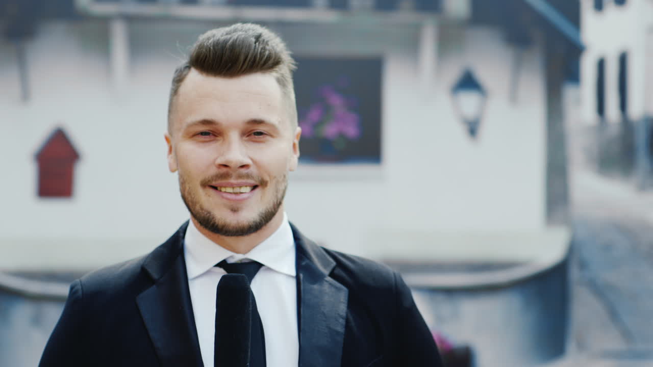 Premium stock video - An elegant bold-looking man speaks into the ...