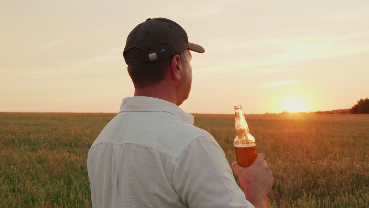 Premium stock video - The farmer enjoys drinking beer