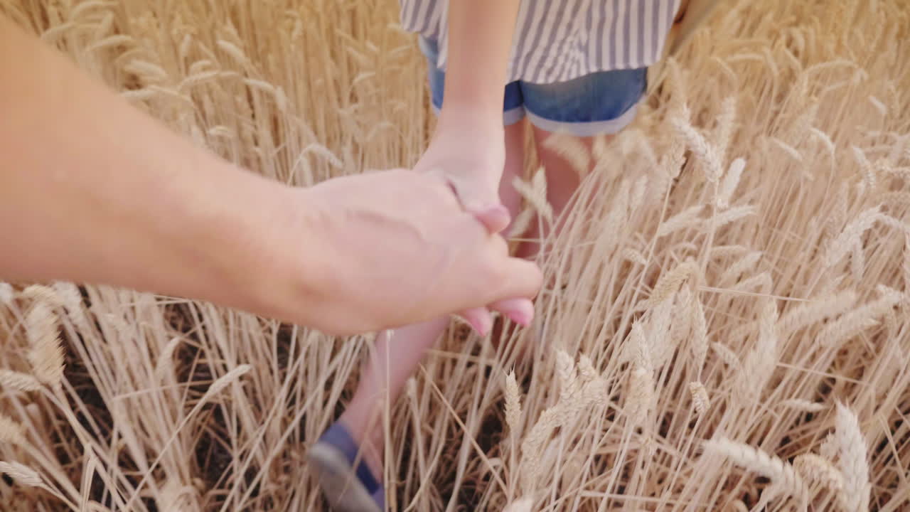 Premium stock video - A woman's hand holds a man's hand leading to a ...