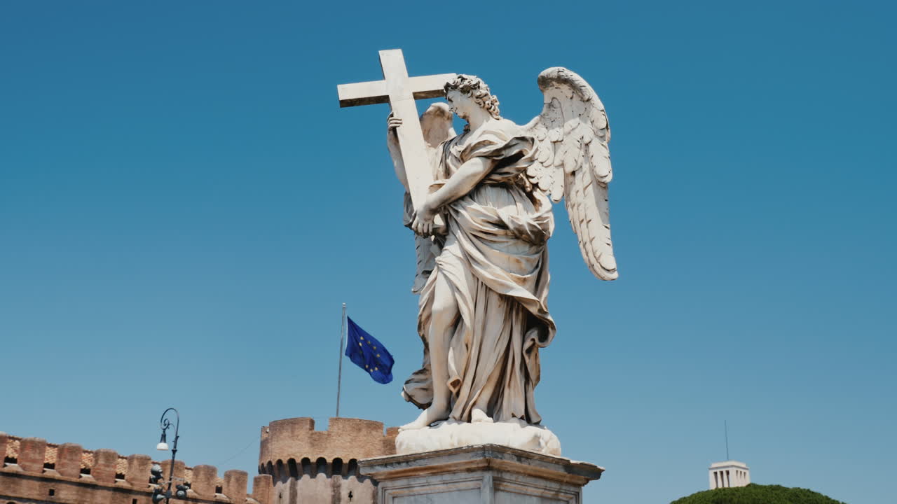 Premium stock video - Steadicam shot: statue of an angel with a cross ...