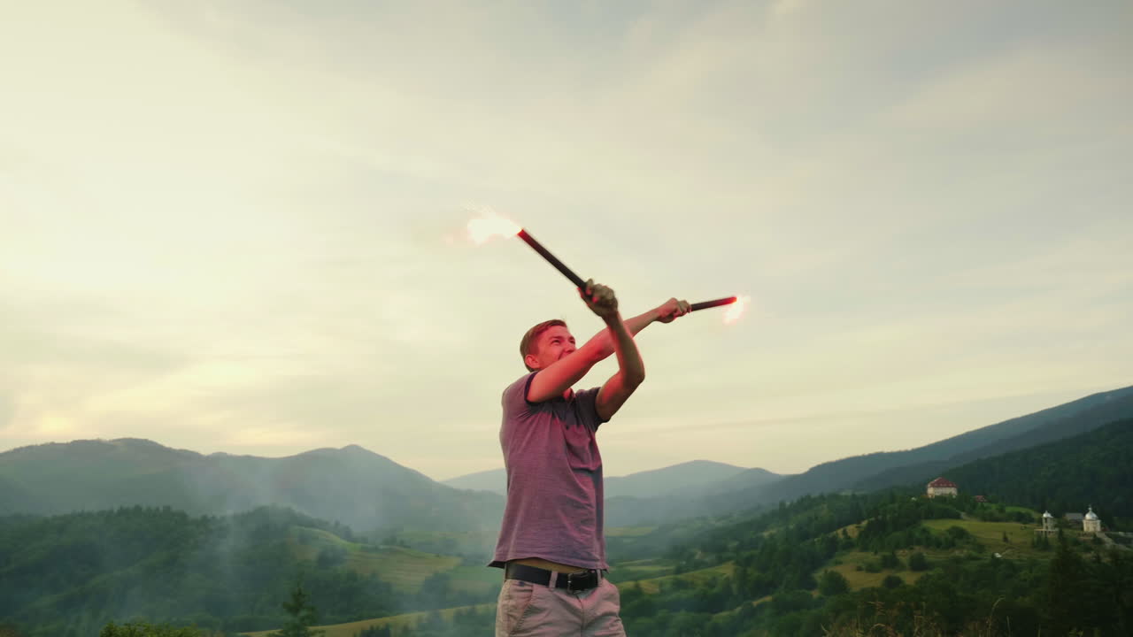 Premium stock video - A man in the mountains signals with hand ...