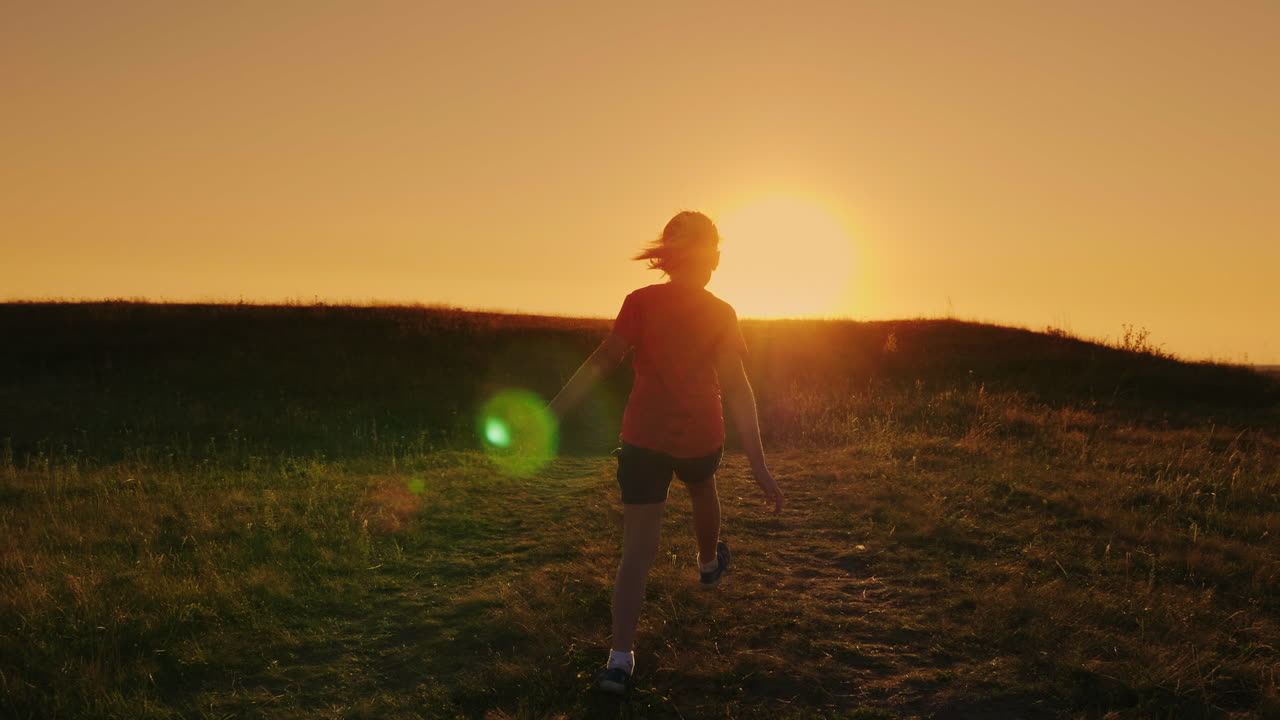 Premium stock video - Carefree girl skipping fun at sunset